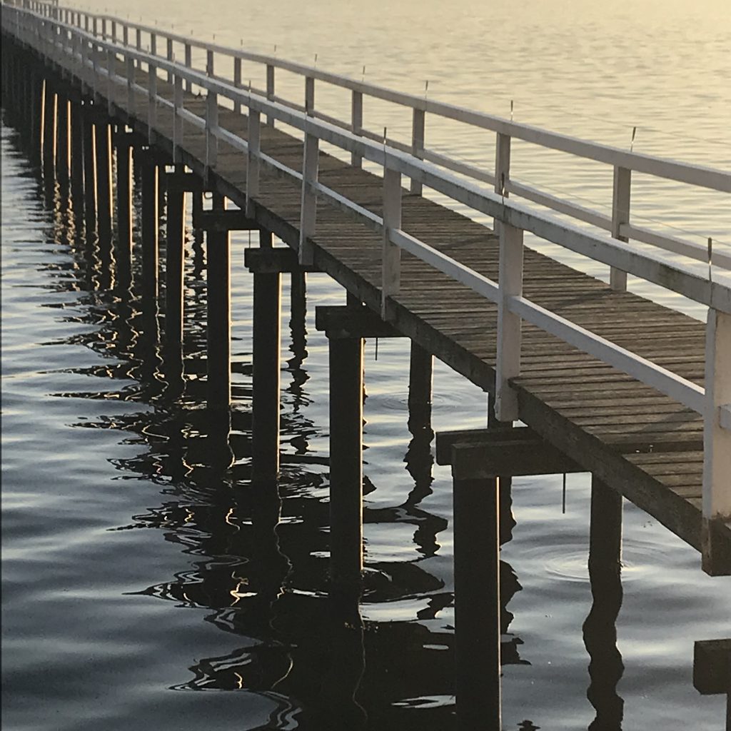 Determining the slope of sea surface via the reflection of a structure ...